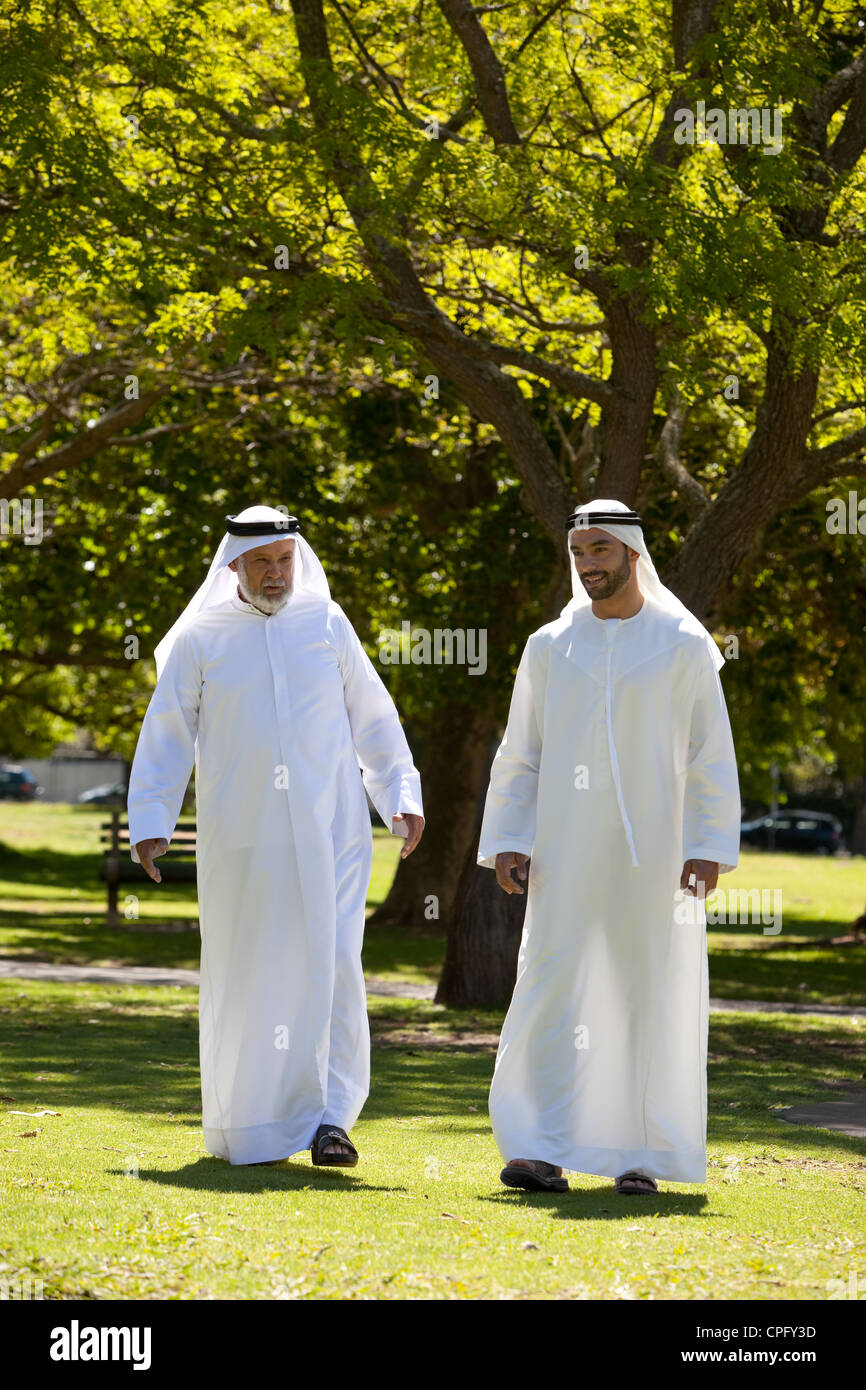 Arab father and son walking together at the park Stock Photo - Alamy