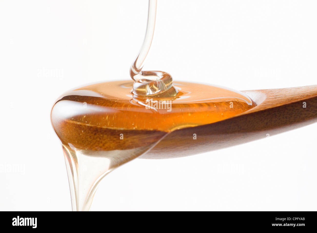 Full Spoon Of Honey Stock Photo - Alamy