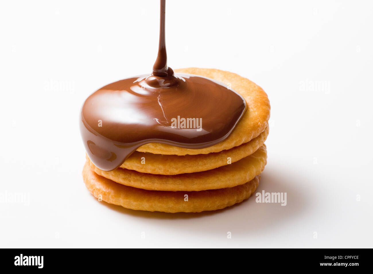 Melt Chocolate Dropping On Stack Of Biscuit Stock Photo - Alamy