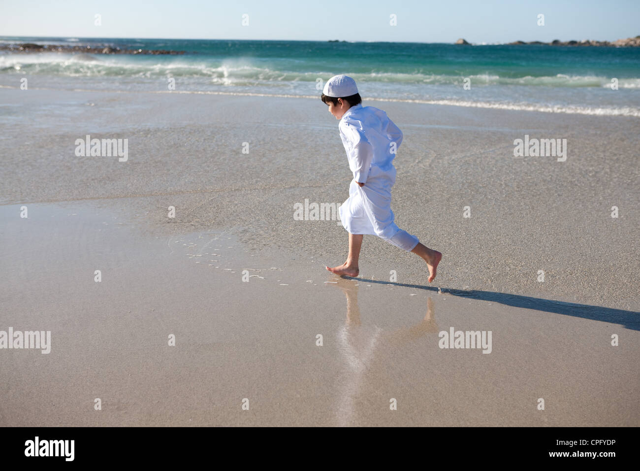 Arab boy running at the beach Stock Photo - Alamy