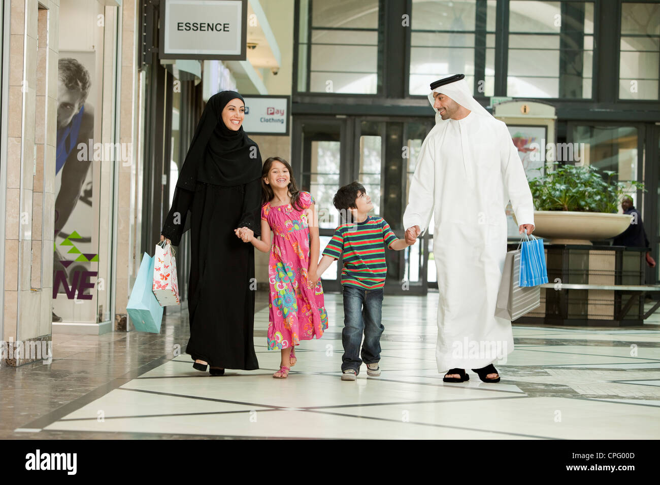 Arab family holding hands while walking in the shopping mall Stock ...