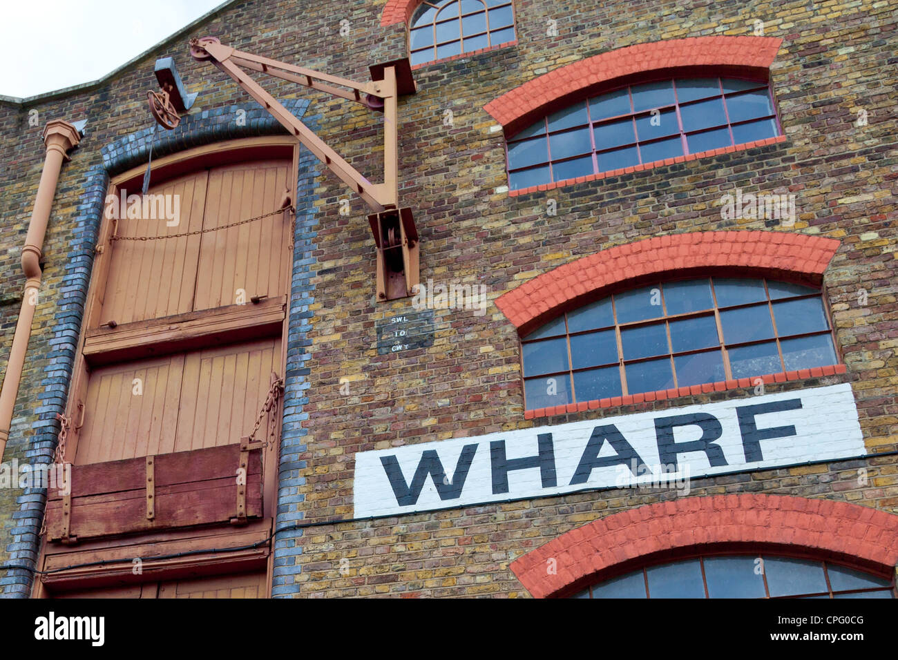 Old wharf building with crane, Wapping, London Stock Photo - Alamy
