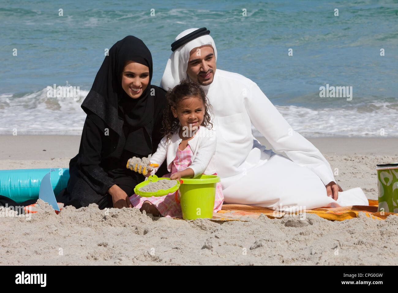 Arab family playing on the sand at the beach Stock Photo - Alamy