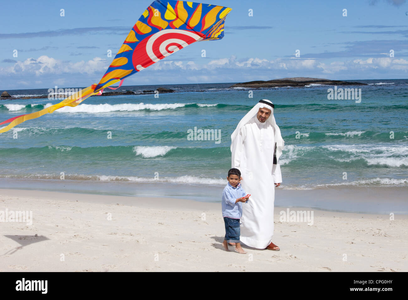 Arab father and son with kite walking at the beach Stock Photo - Alamy