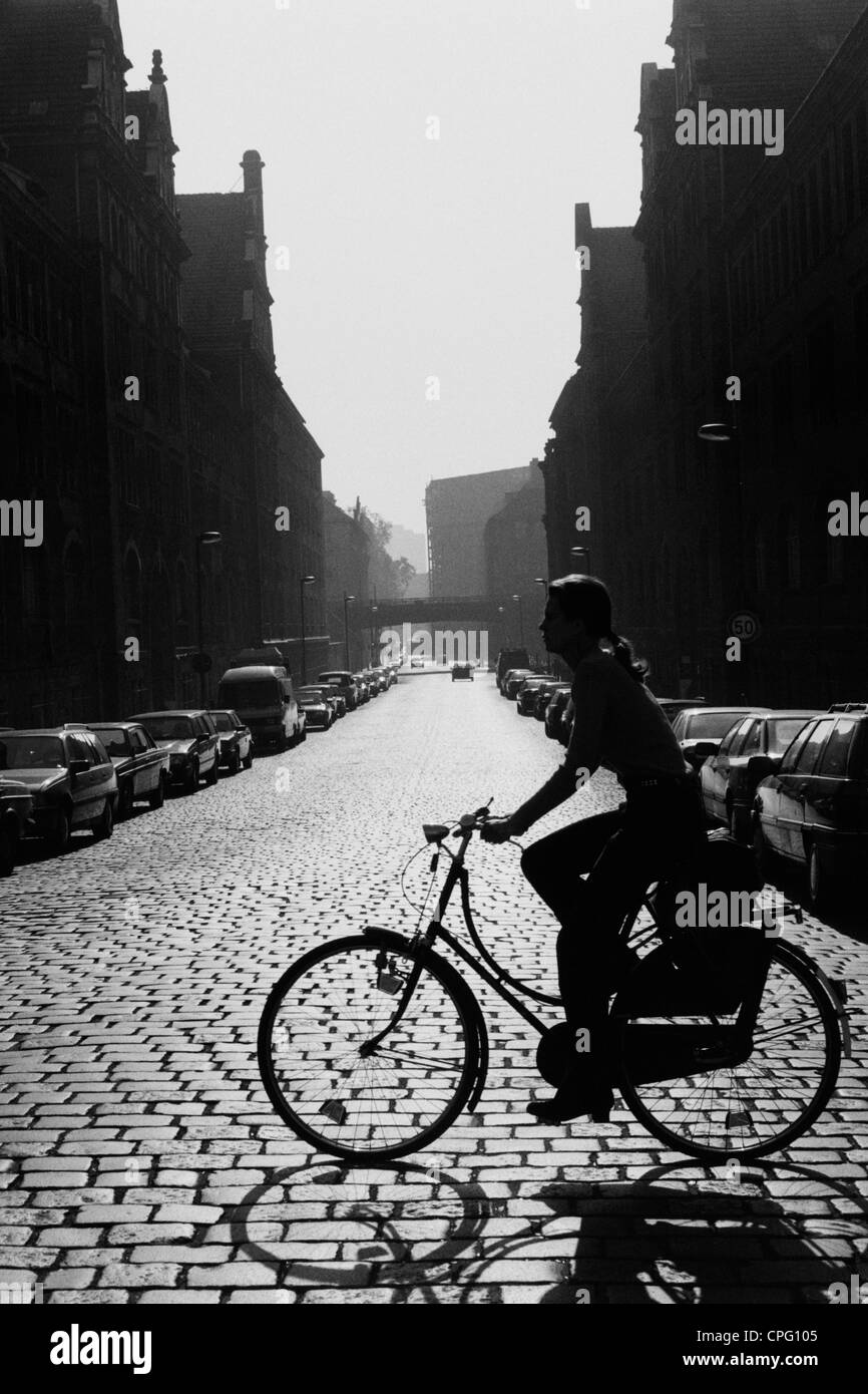 A woman on a bicycle crossing the street, Berlin, Germany Stock Photo ...