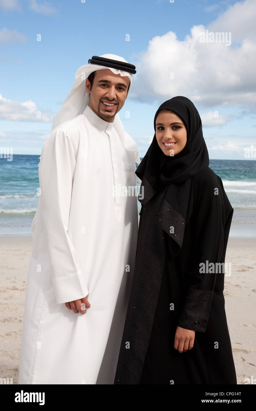 Portrait of arab couple at the beach, smiling Stock Photo - Alamy