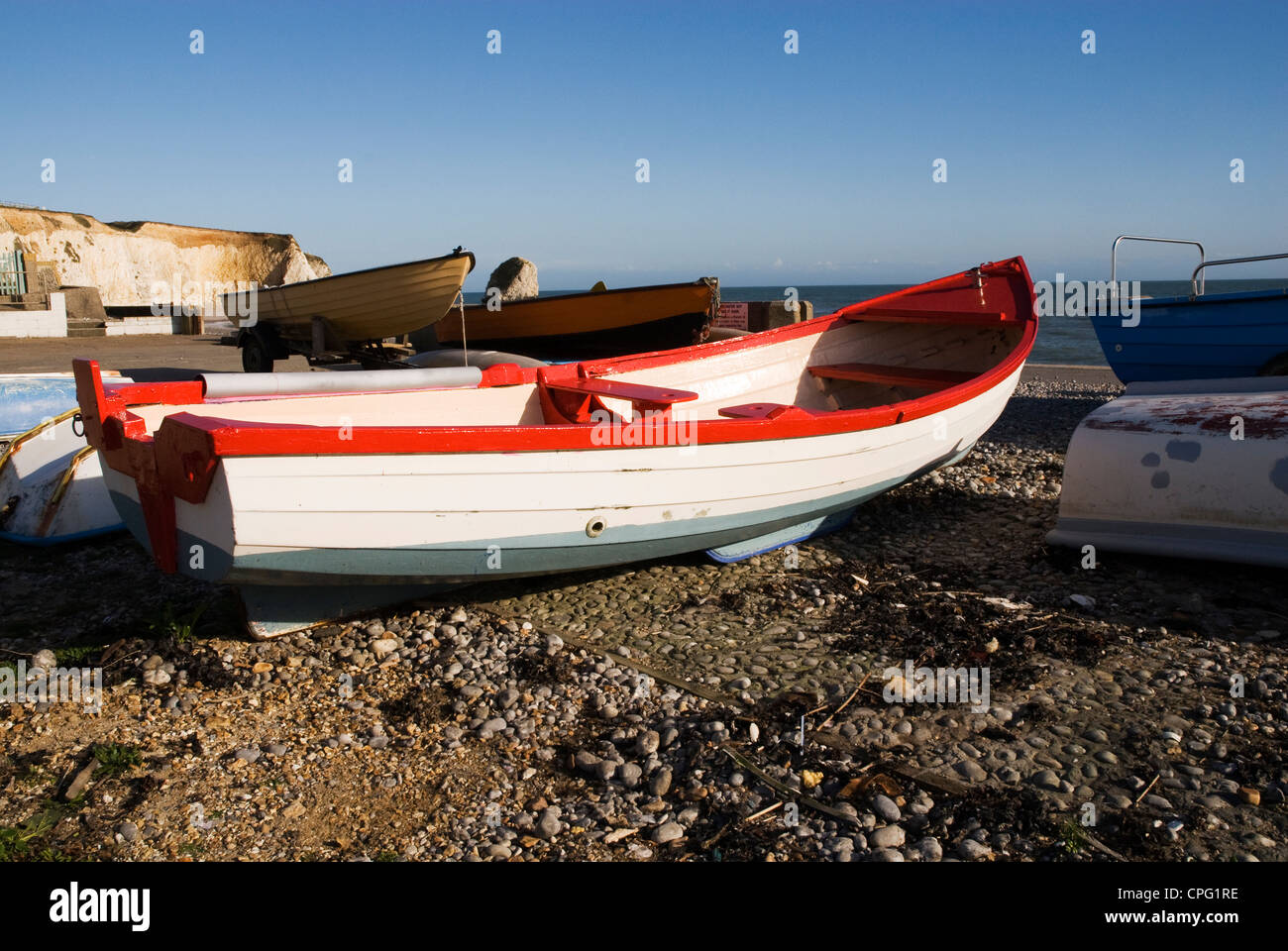 A small rowing boat named SUE on a pebble beach Stock Photo - Alamy