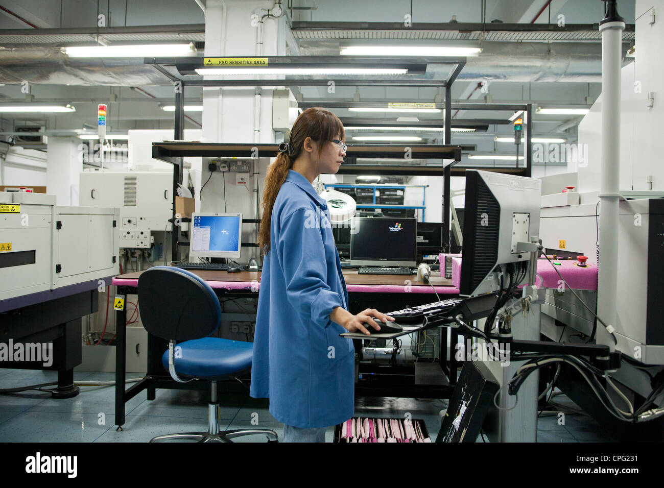 A worker on the assembly line at the Venture Corp. factory in Singapore ...