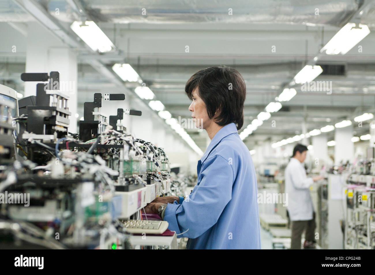 Workers assemble hand-held inventory computer devices on the assembly ...