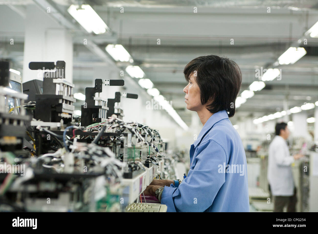 Workers assemble hand-held inventory computer devices on the assembly ...