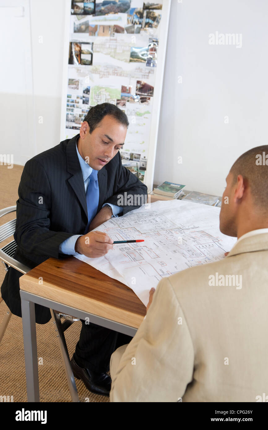 Two businessmen discussing over blueprint Stock Photo - Alamy Two businessmen discussing over blueprint Stock Photo - Alamy