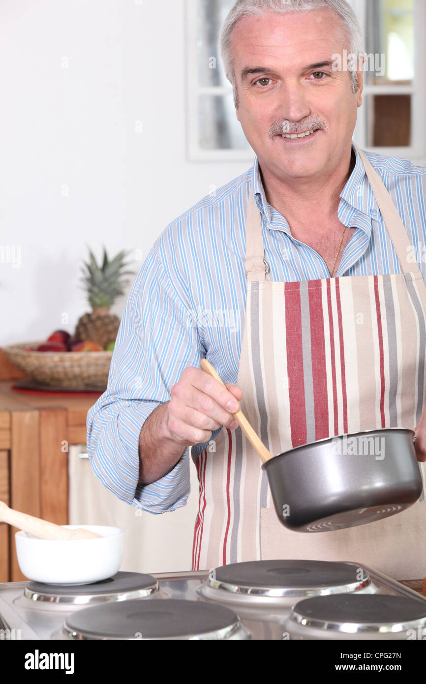 Senior man cooking Stock Photo - Alamy