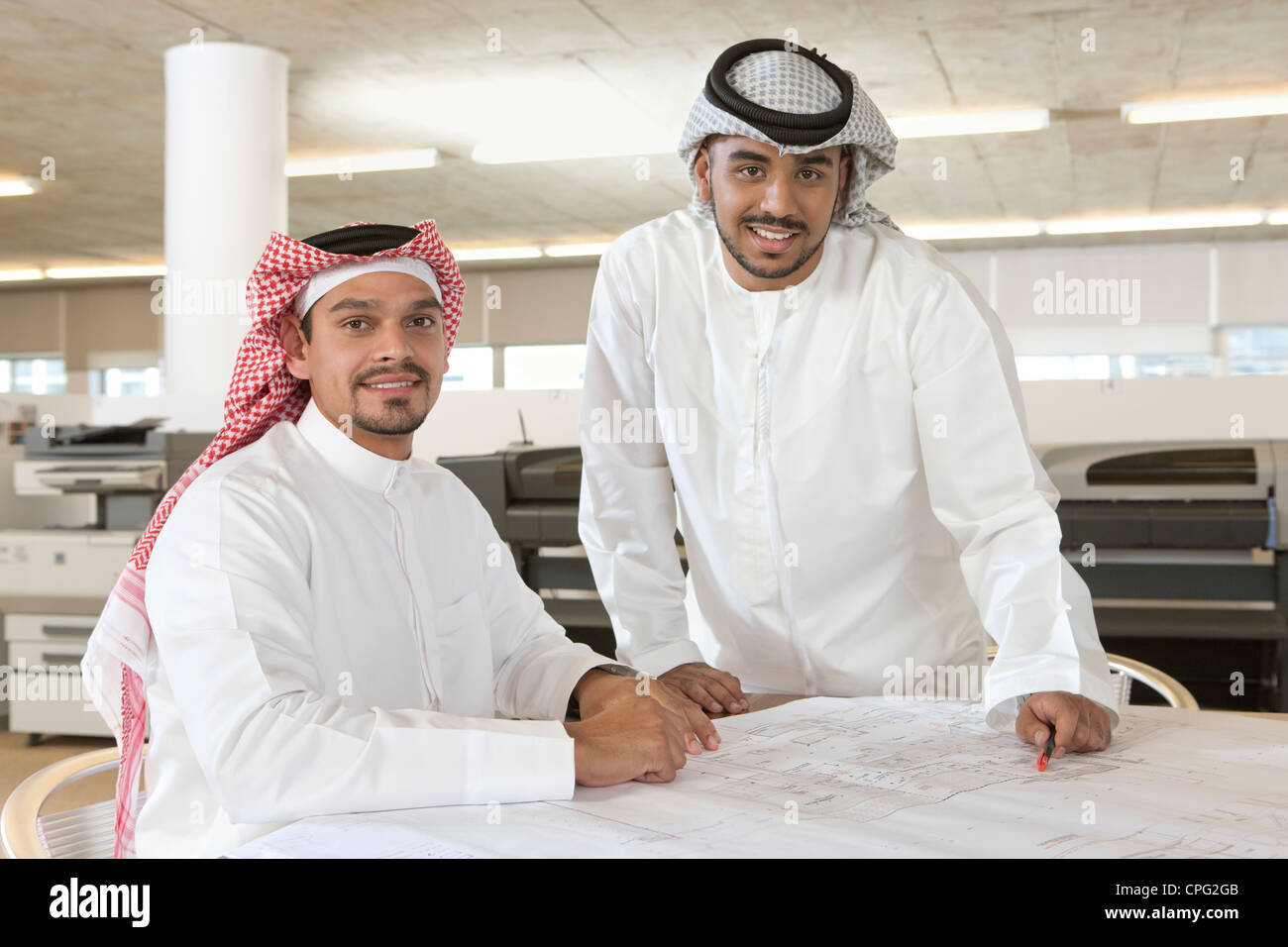 Two arab businessmen discussing over blueprint Stock Photo - Alamy