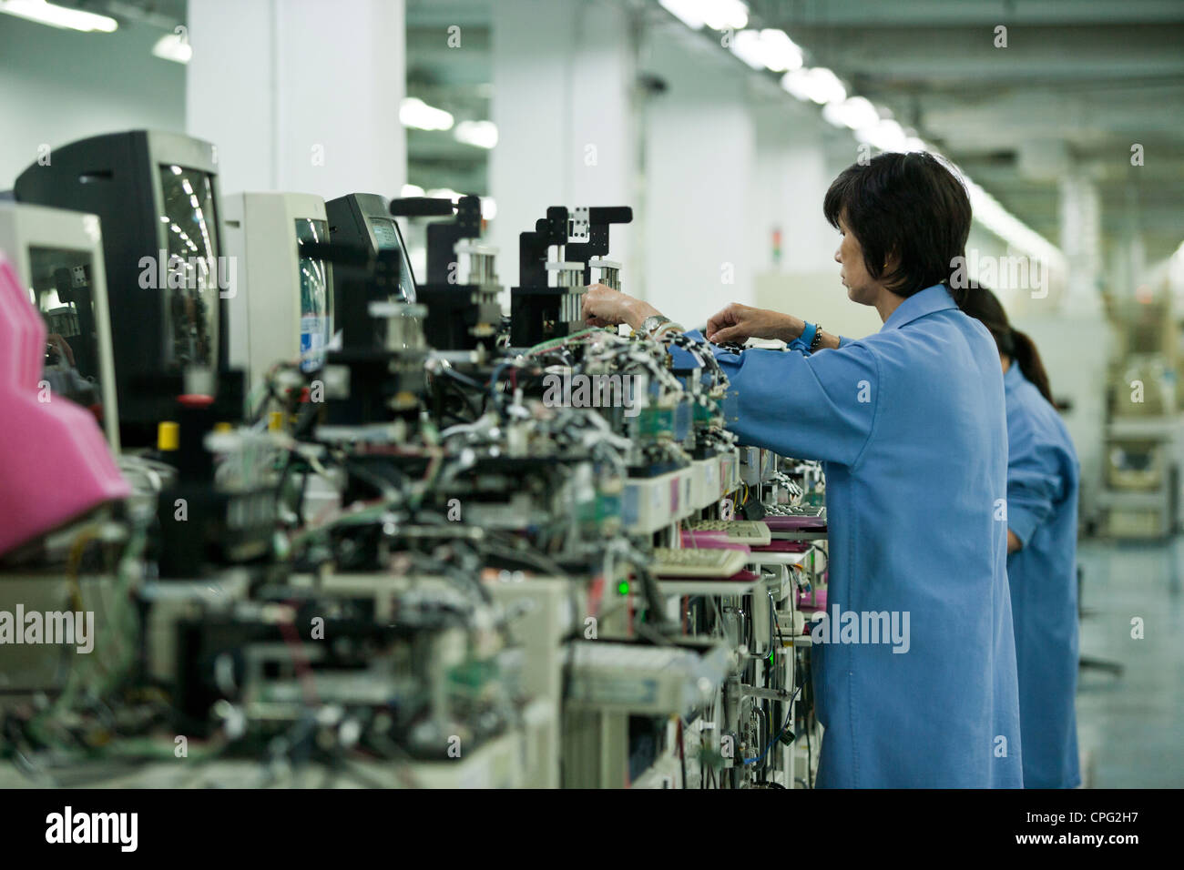 Workers assemble hand-held inventory computer devices on the assembly ...