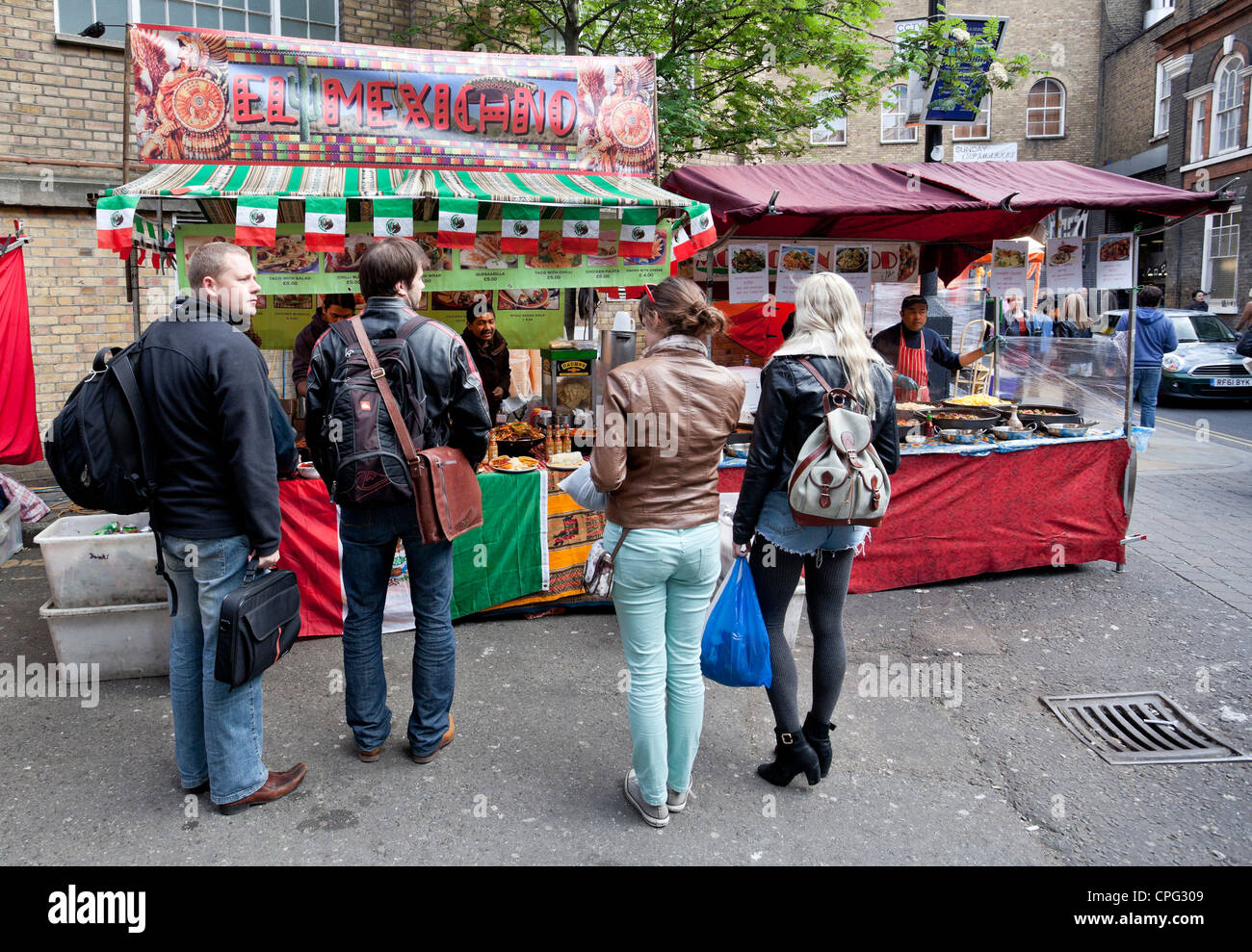 People waiting in line at a food stall, Brick Lane, Spitalfields ...