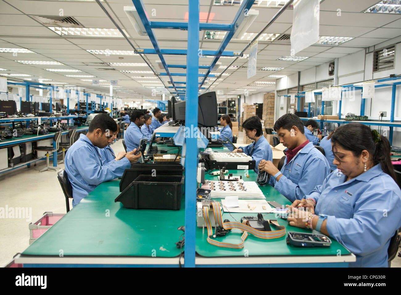 Workers assemble hand-held inventory computer devices on the assembly ...