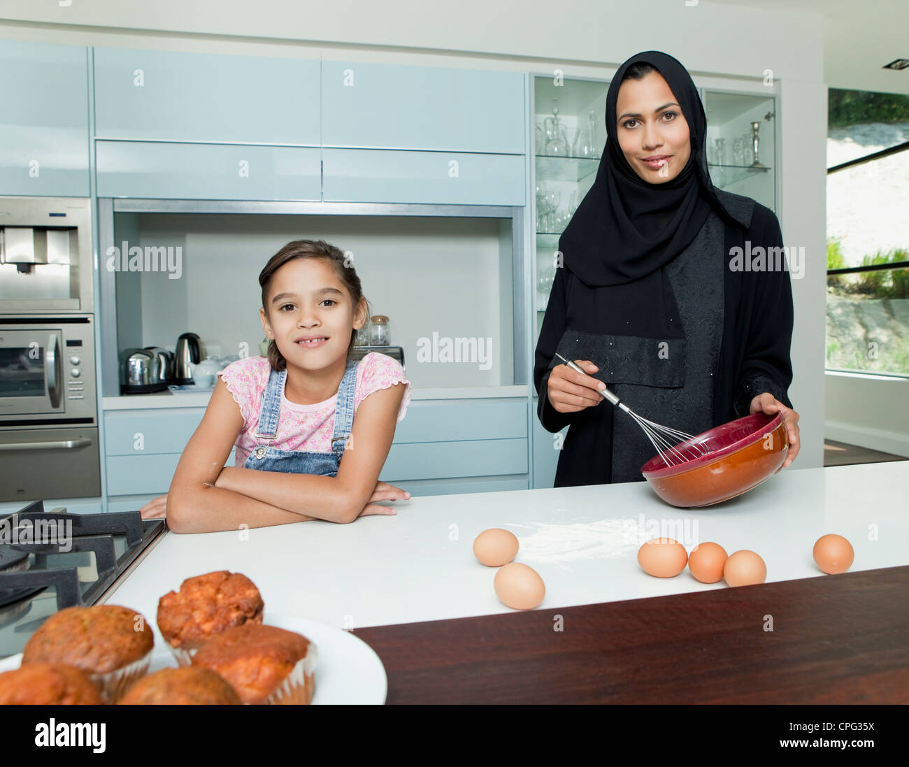 Arab mother and daughter baking in the kitchen Stock Photo - Alamy