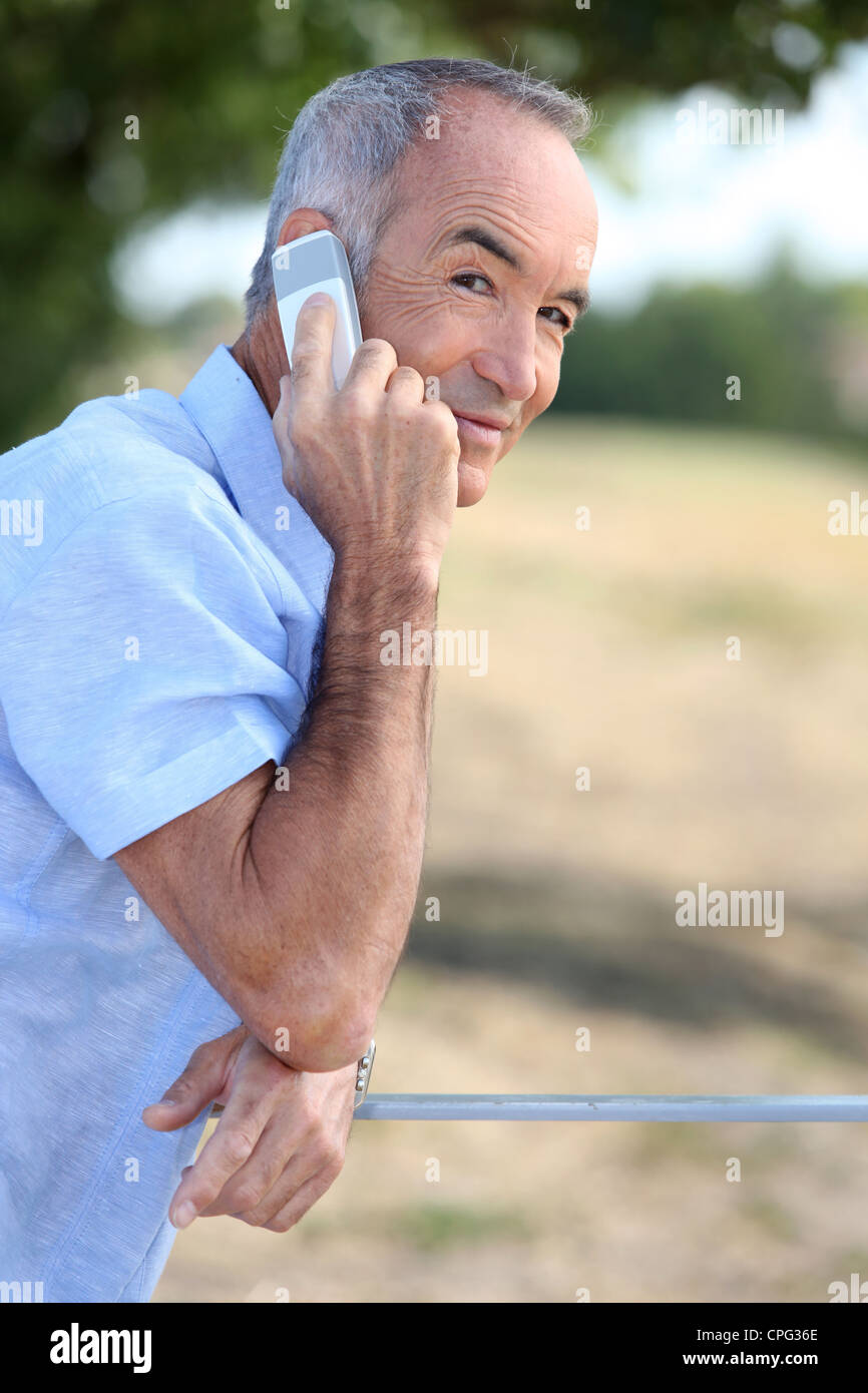 Middle-aged man, making telephone call outdoors Stock Photo - Alamy