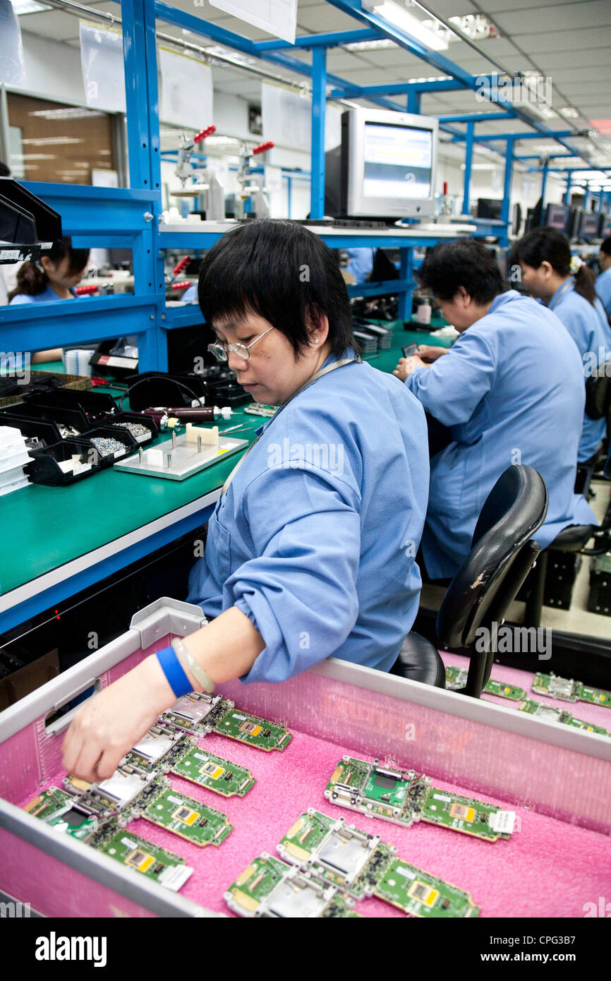 Workers assemble hand-held inventory computer devices on the assembly ...