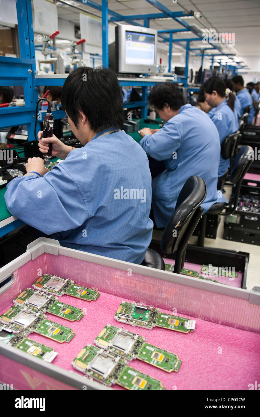 Workers assemble hand-held inventory computer devices on the assembly ...