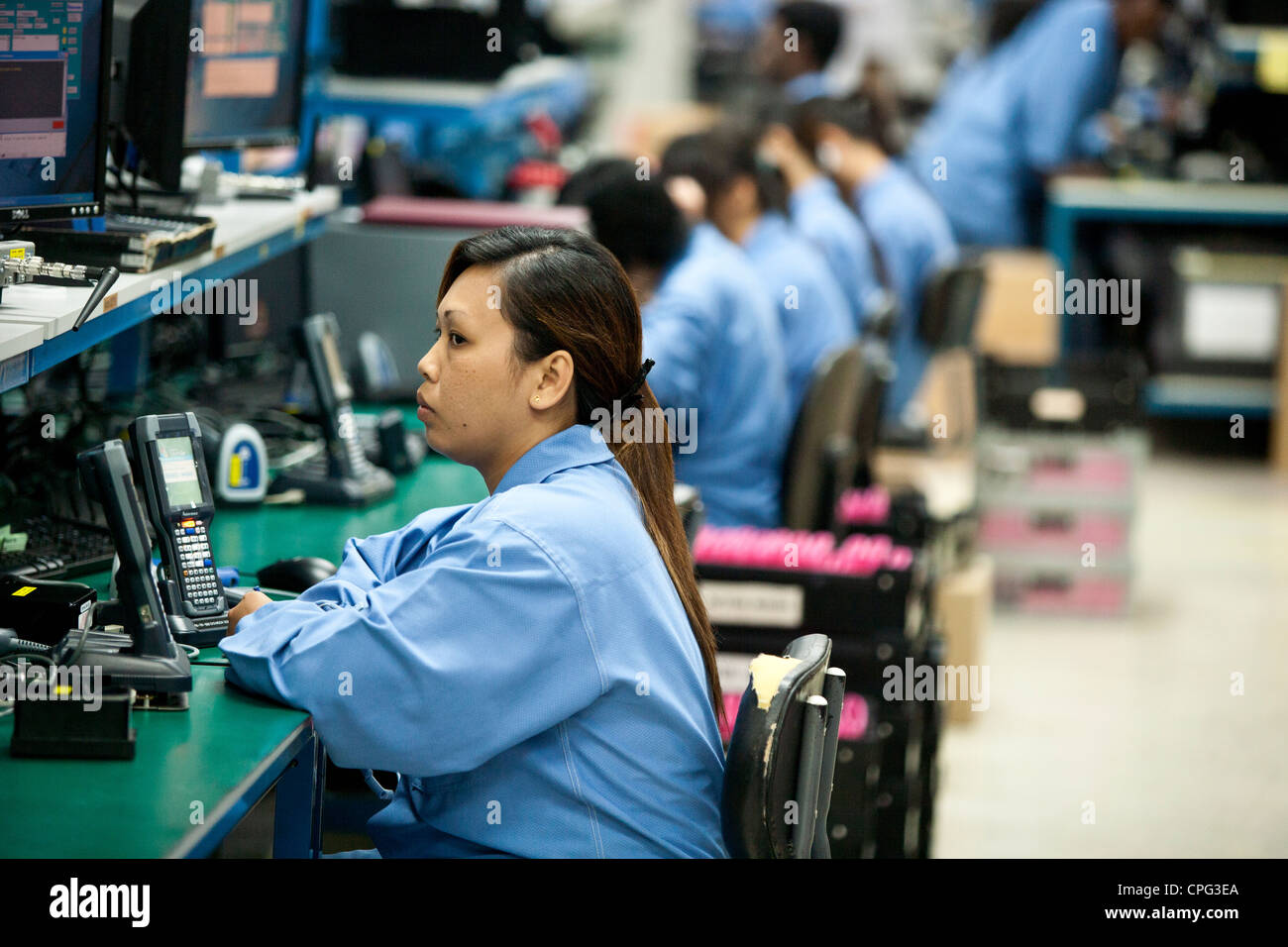 Workers assemble hand-held inventory computer devices on the assembly ...
