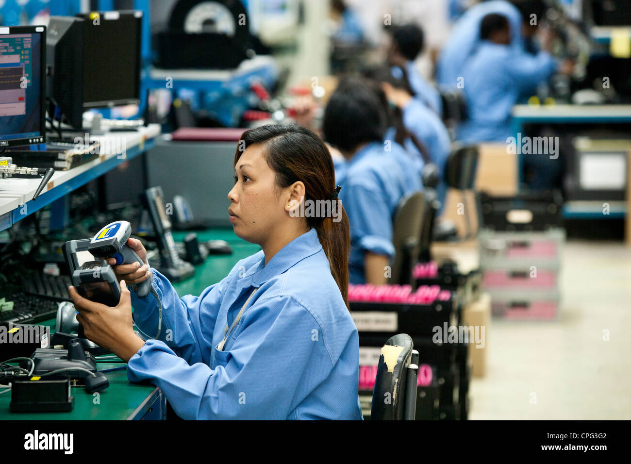 Workers assemble hand-held inventory computer devices on the assembly ...