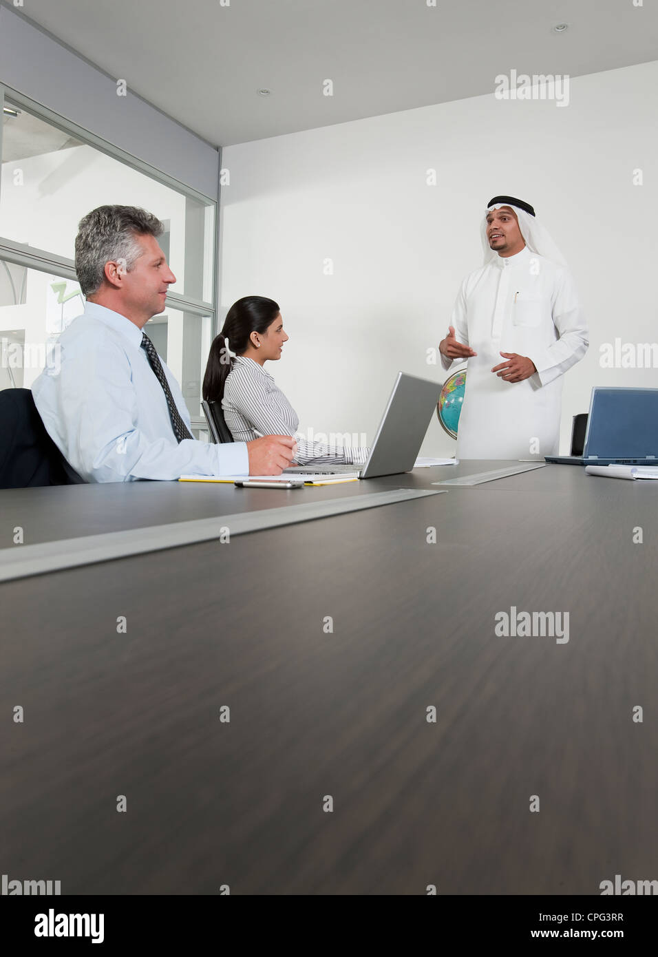 Three business people having meeting in office Stock Photo - Alamy