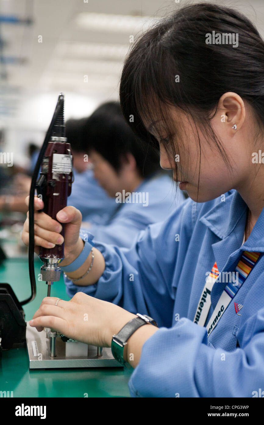 Workers assemble hand-held inventory computer devices on the assembly ...