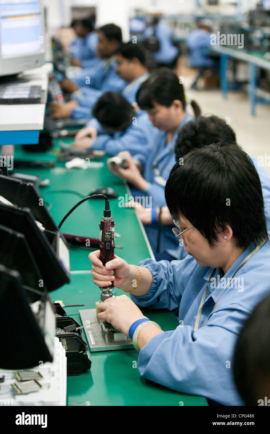 Workers assemble hand-held inventory computer devices on the assembly ...