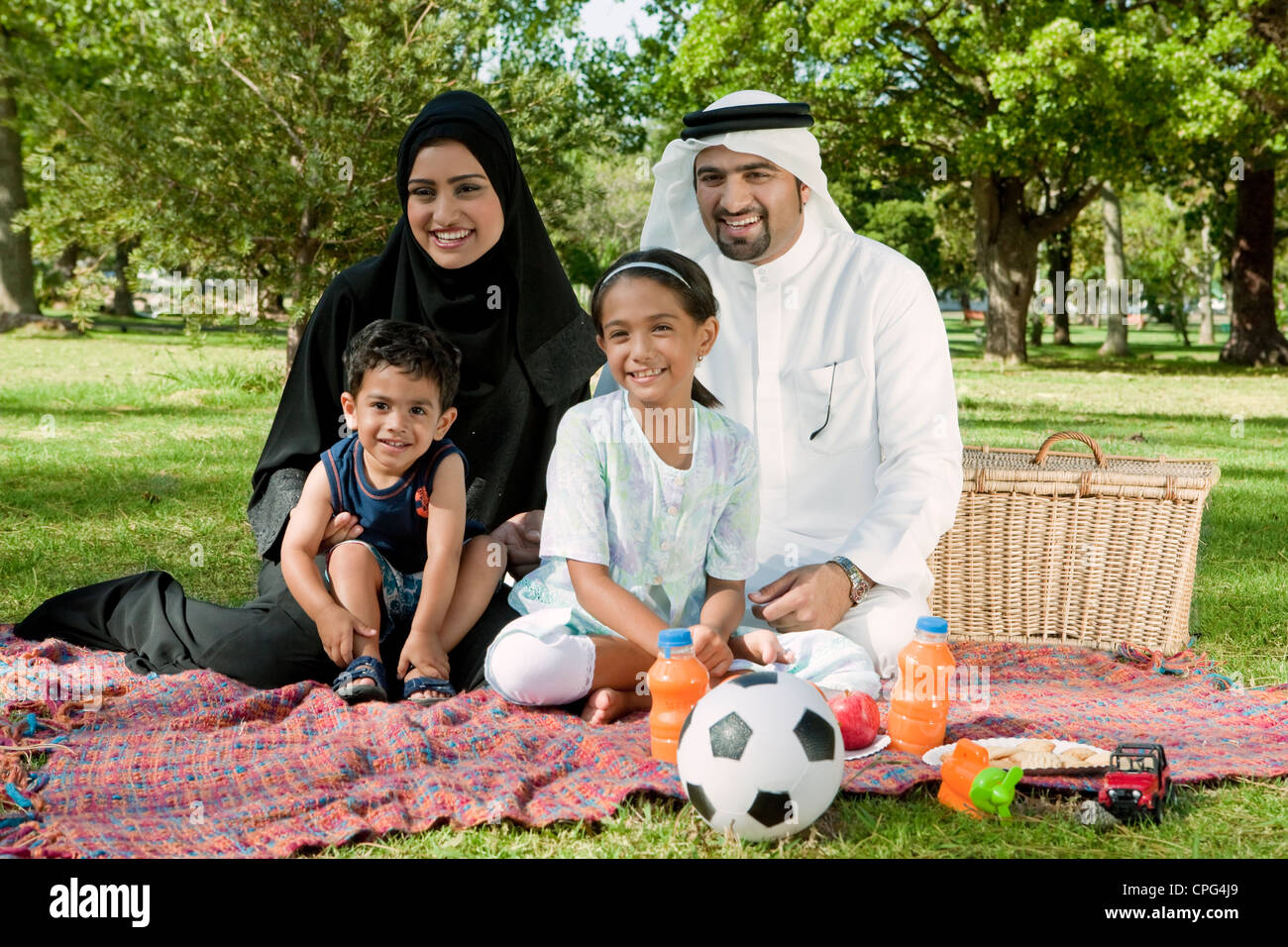 Portrait of arab family in the park, smiling Stock Photo - Alamy