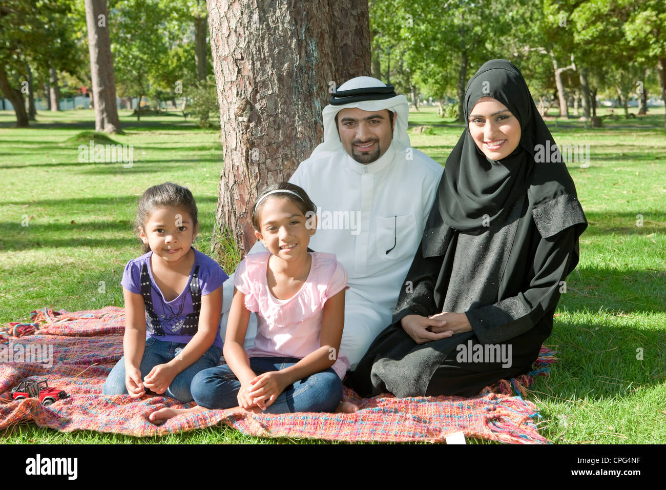 Portrait of arab family sitting in the park Stock Photo - Alamy
