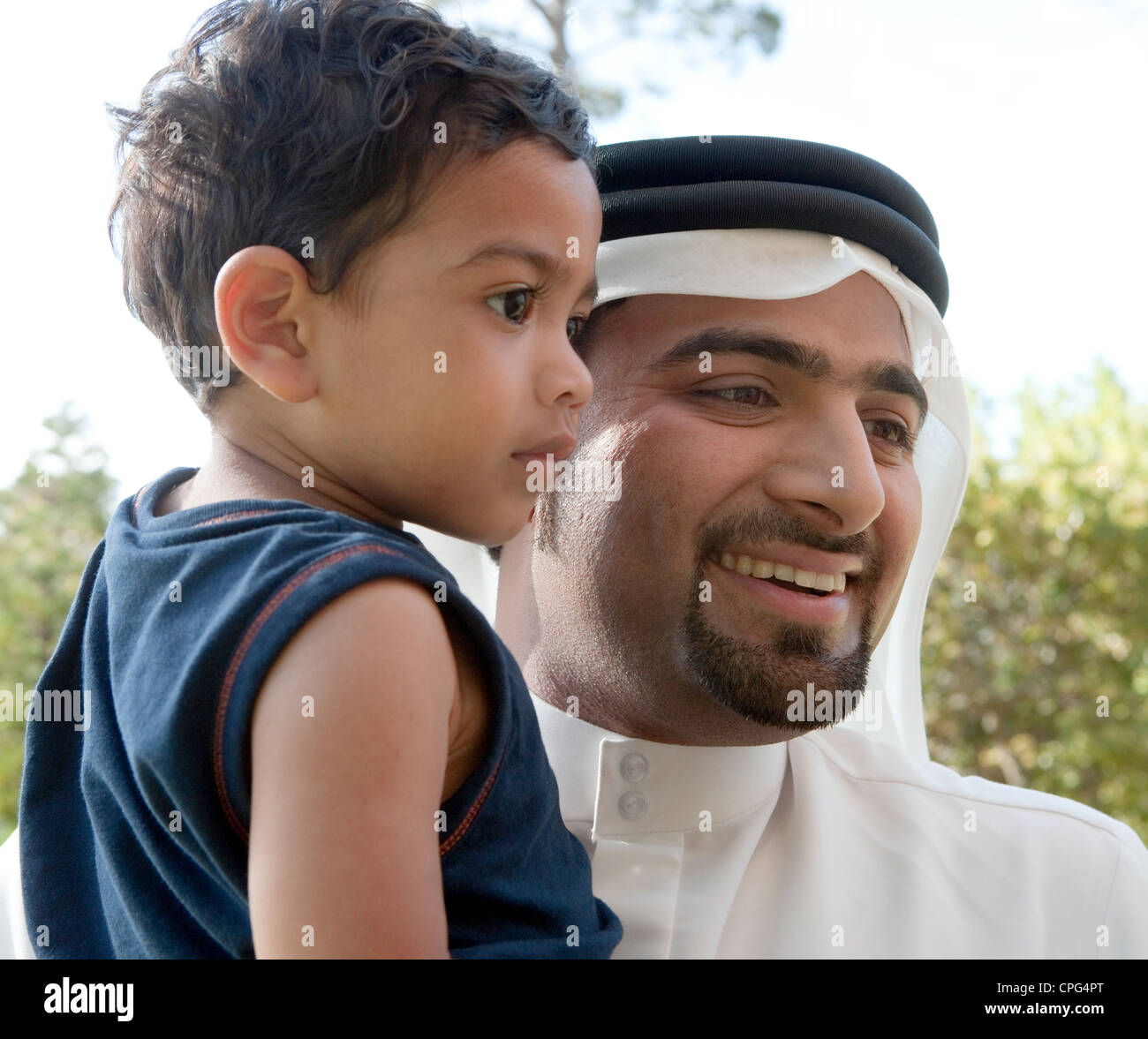 Arab father carrying his son at the park, smiling Stock Photo - Alamy