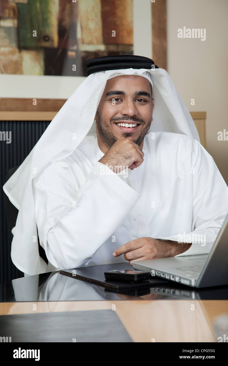 Arab businessman laptop smiling camera hi-res stock photography and ...