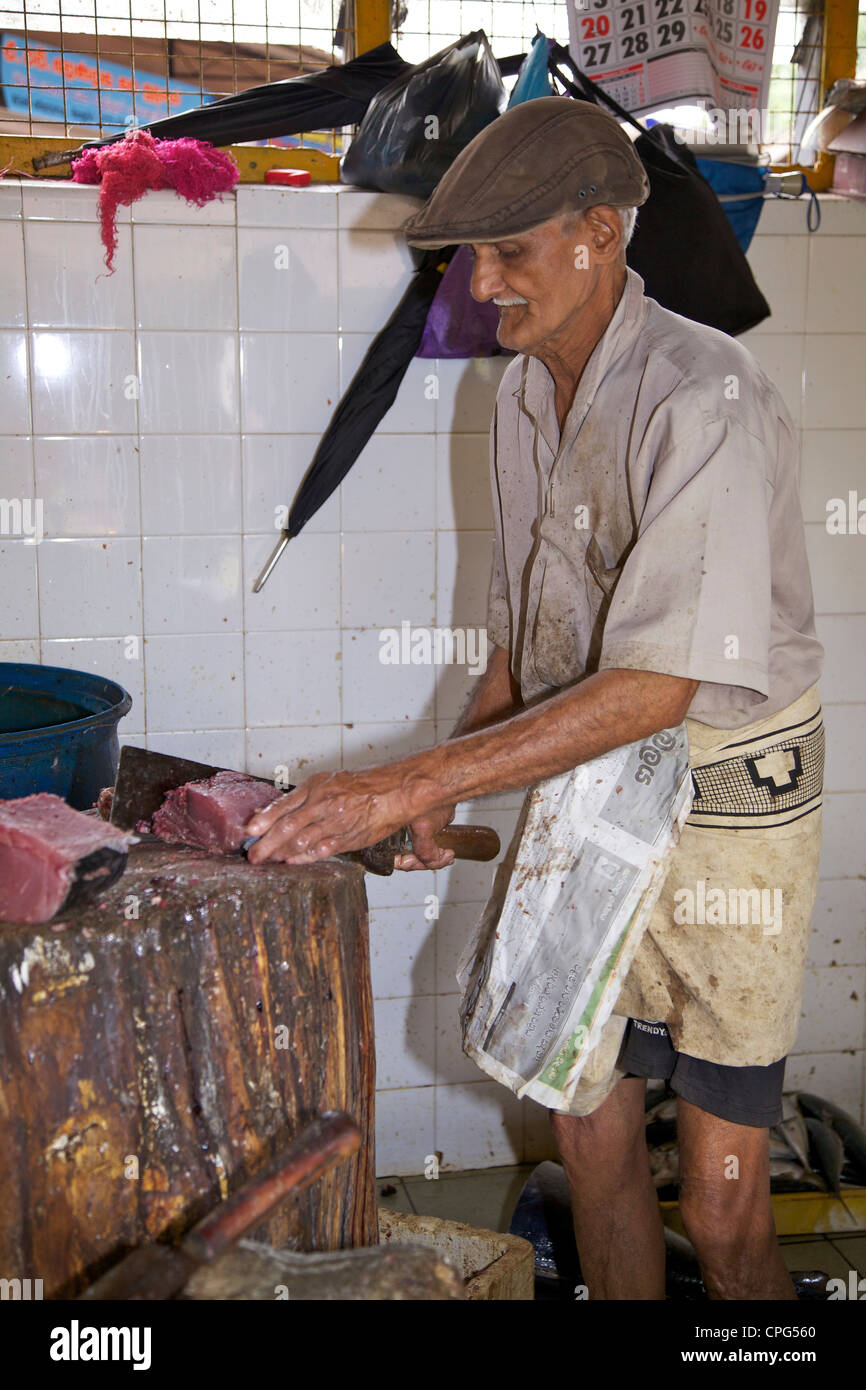 Fishmonger preparing fresh fish for sale at Kandy Market, Sri Lanka ...