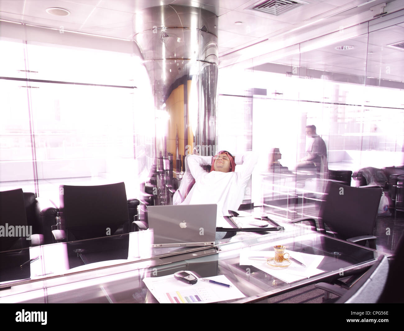 Businessman relaxing in a conference room Stock Photo - Alamy