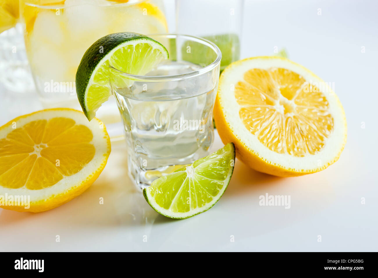 drinks with lemon and lime, shot on reflective white background Stock ...