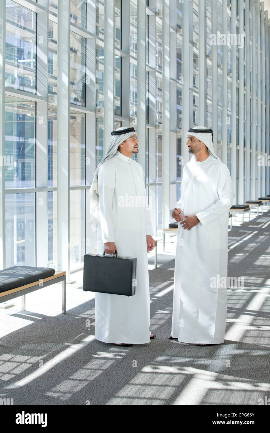 Arab businessmen talking in office hallway Stock Photo - Alamy