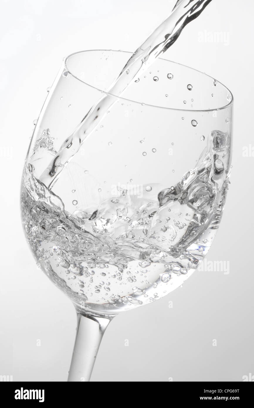 Water Pouring Into Glass Stock Photo - Alamy
