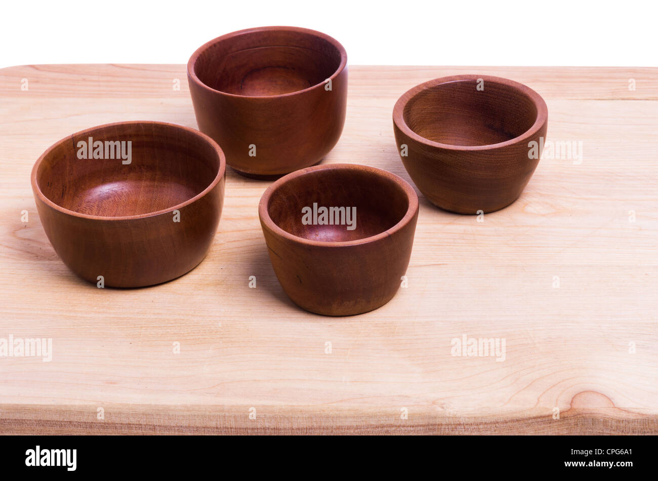 A group of four wooden bowls on a table or cutting board Stock Photo ...