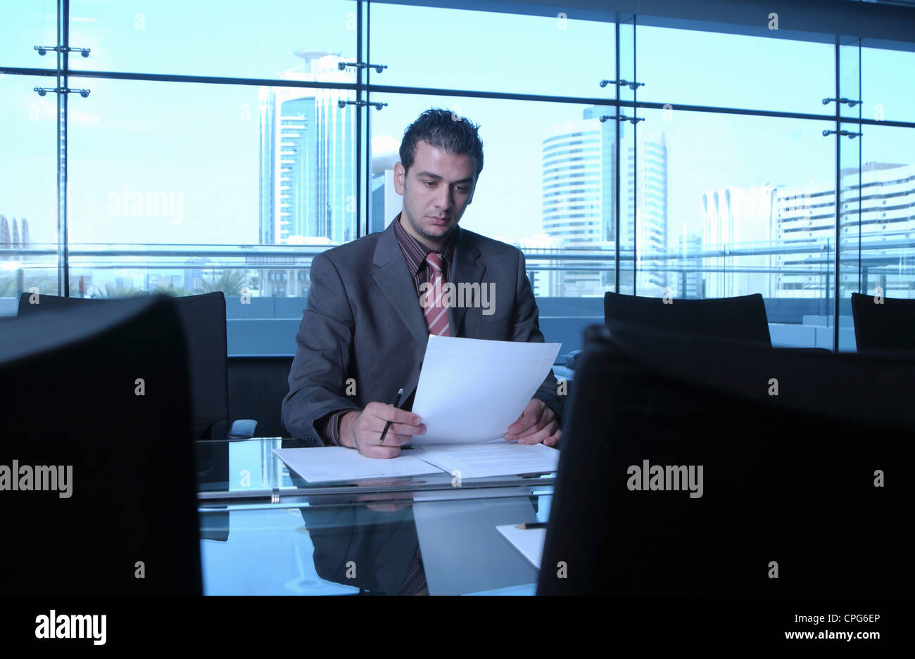 A Businessman focusing on his work inside the office Stock Photo - Alamy