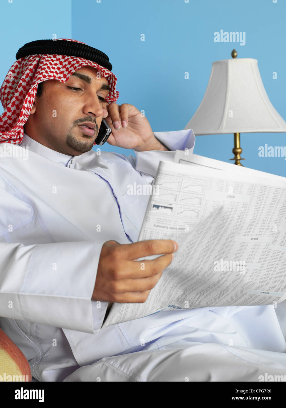 Arab man reading newspaper Stock Photo - Alamy