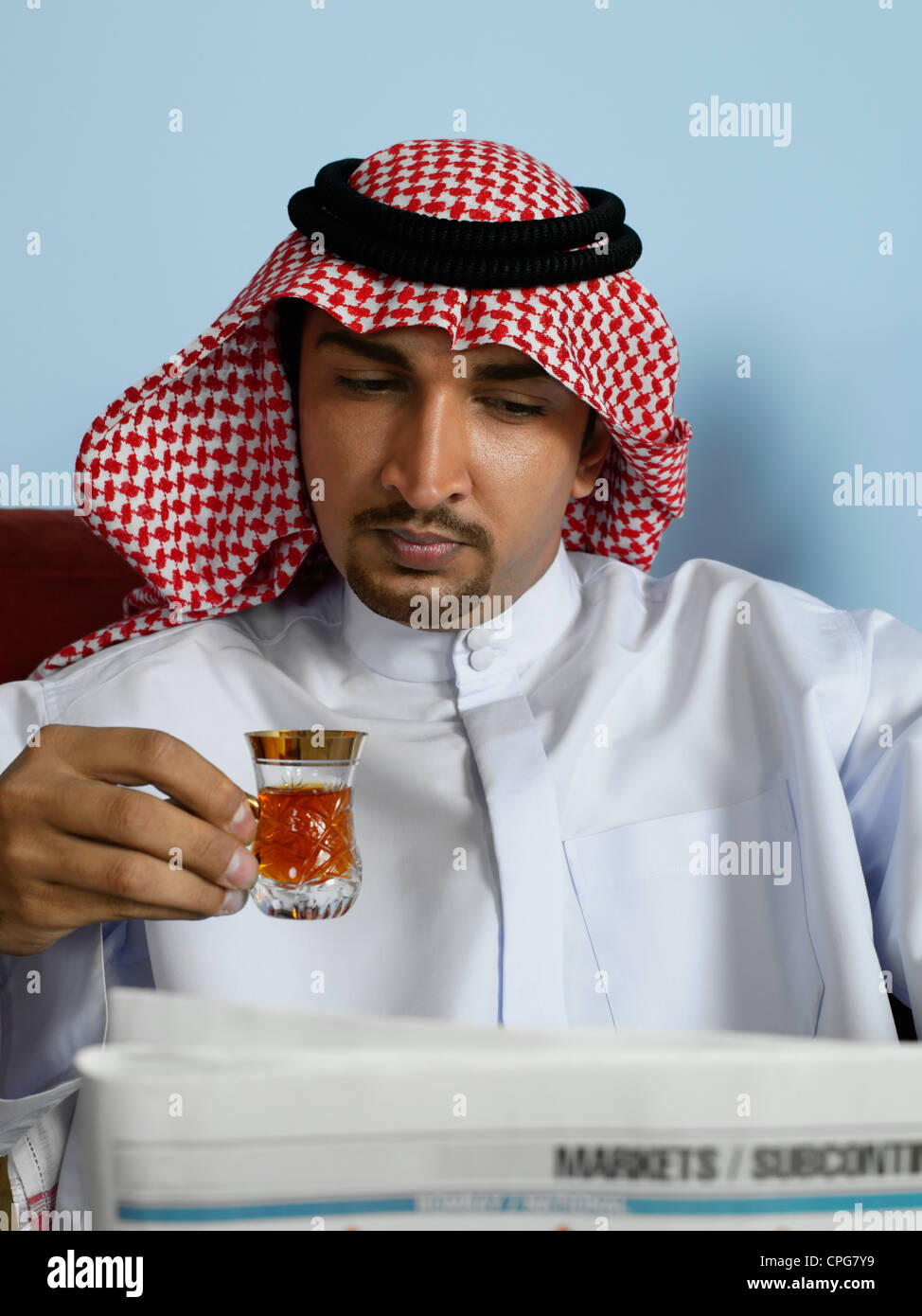 Arab man reading the newspaper Stock Photo - Alamy