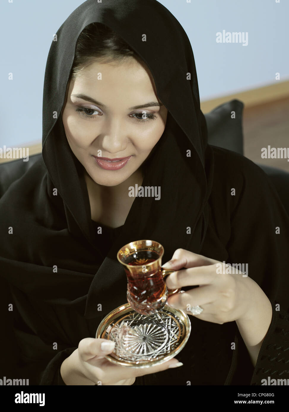 An Arab lady drinking tea Stock Photo - Alamy