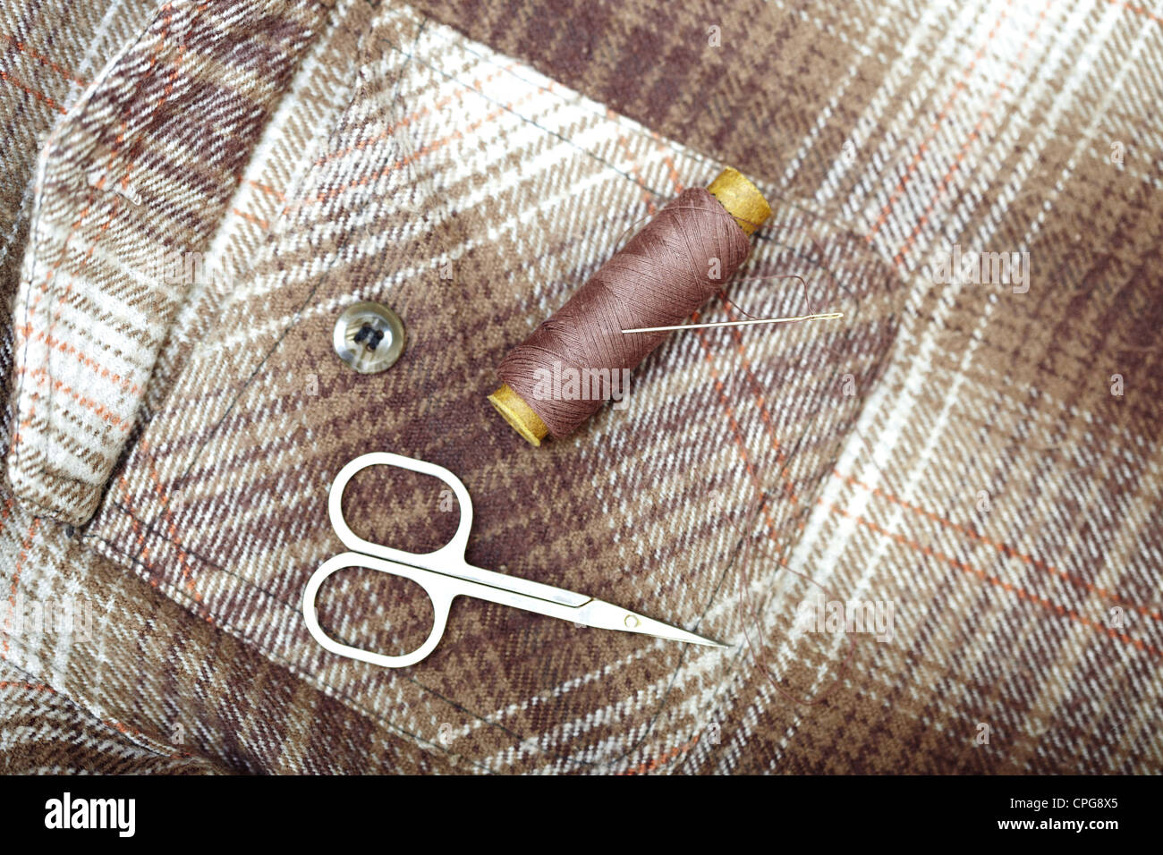 Sewing tools on a brown textile. Horizontal photo Stock Photo - Alamy