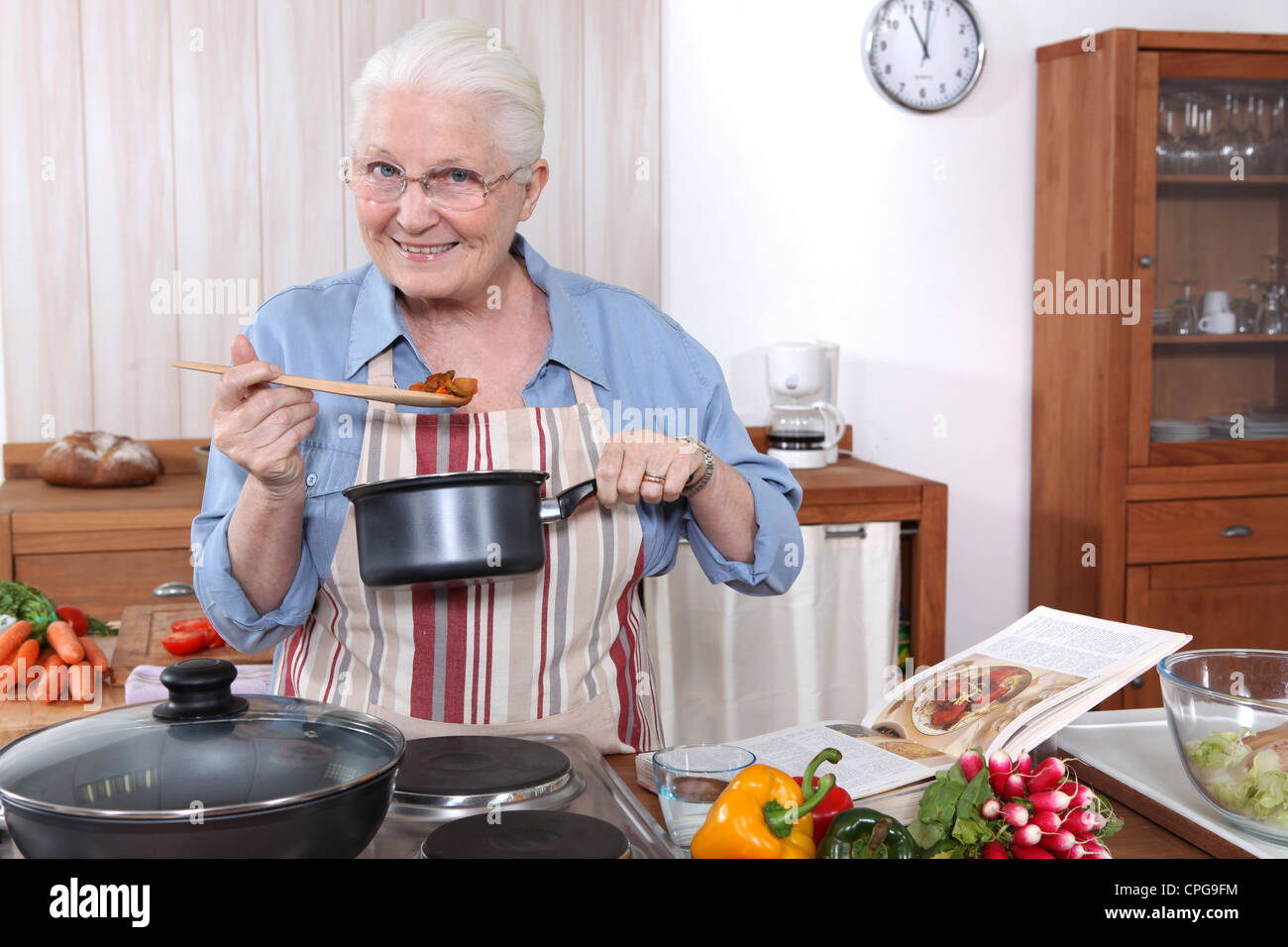 Older woman cooking a meal Stock Photo - Alamy