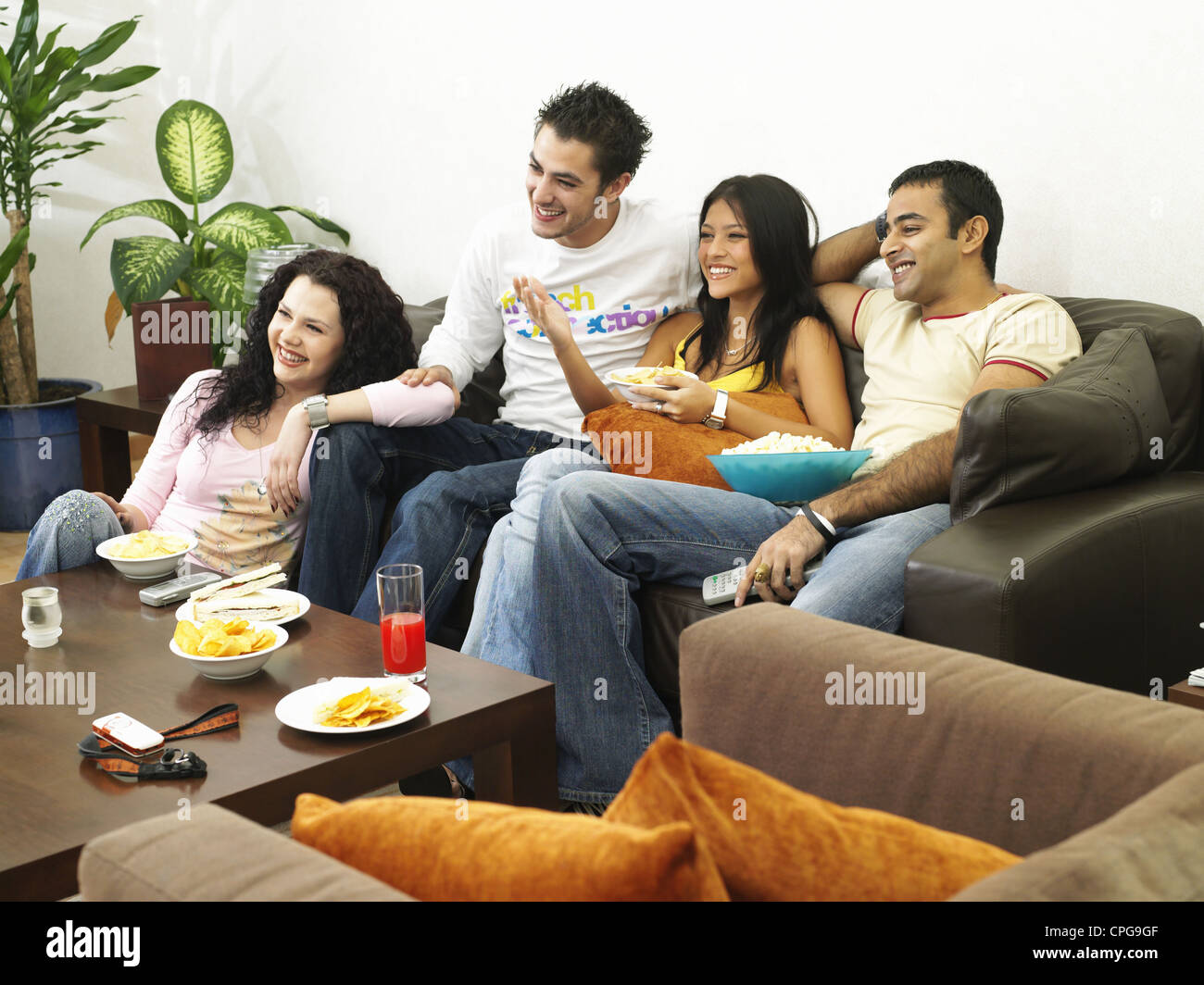 Young people watching television Stock Photo - Alamy