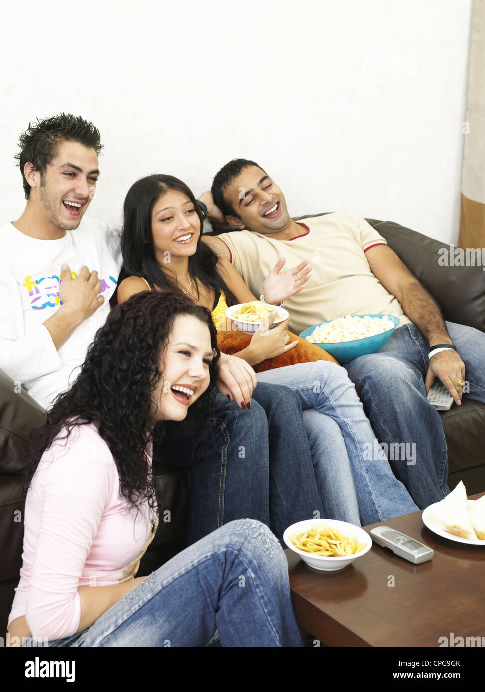 Young people watching television Stock Photo - Alamy