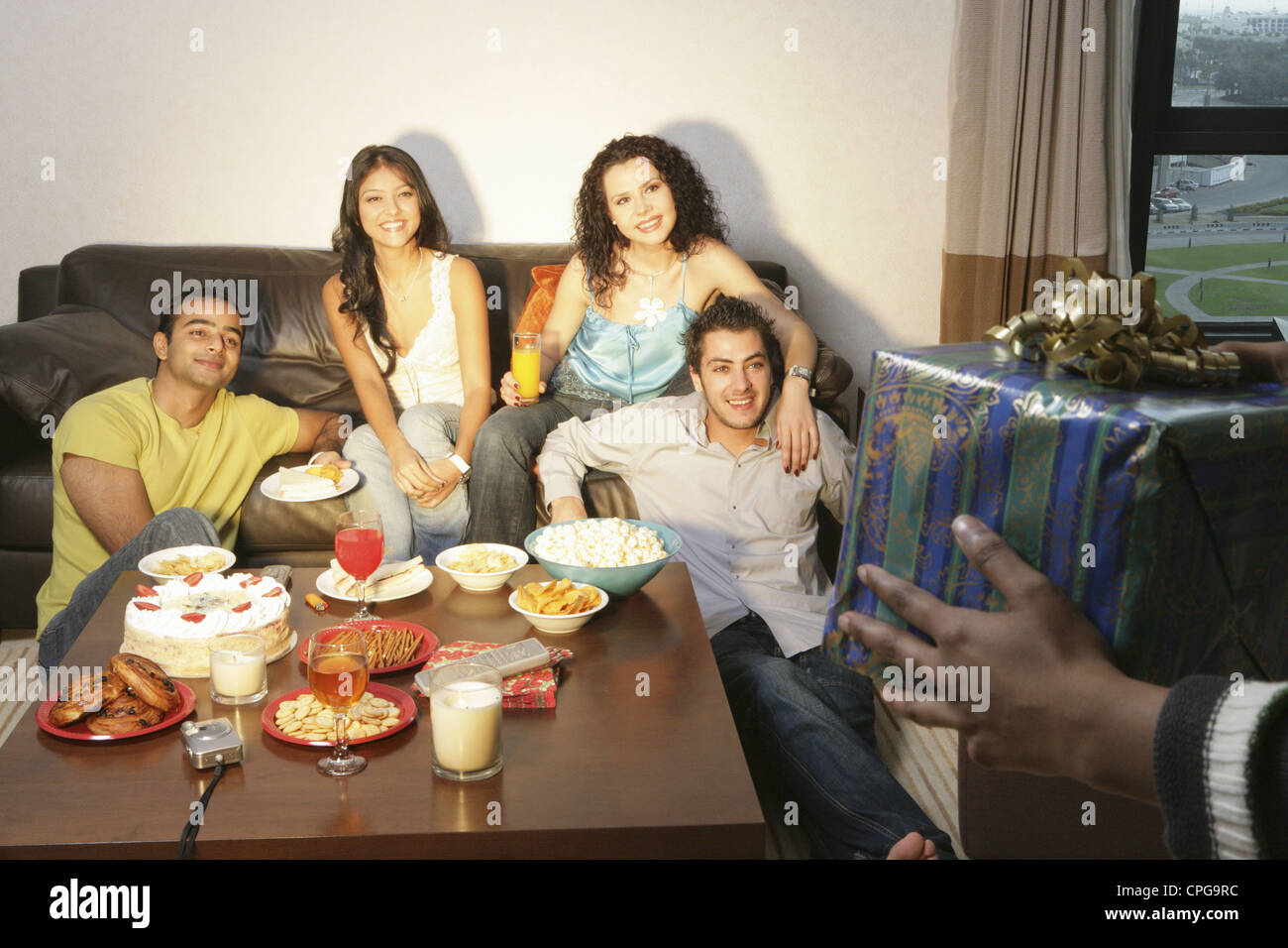Young people socializing at home Stock Photo - Alamy