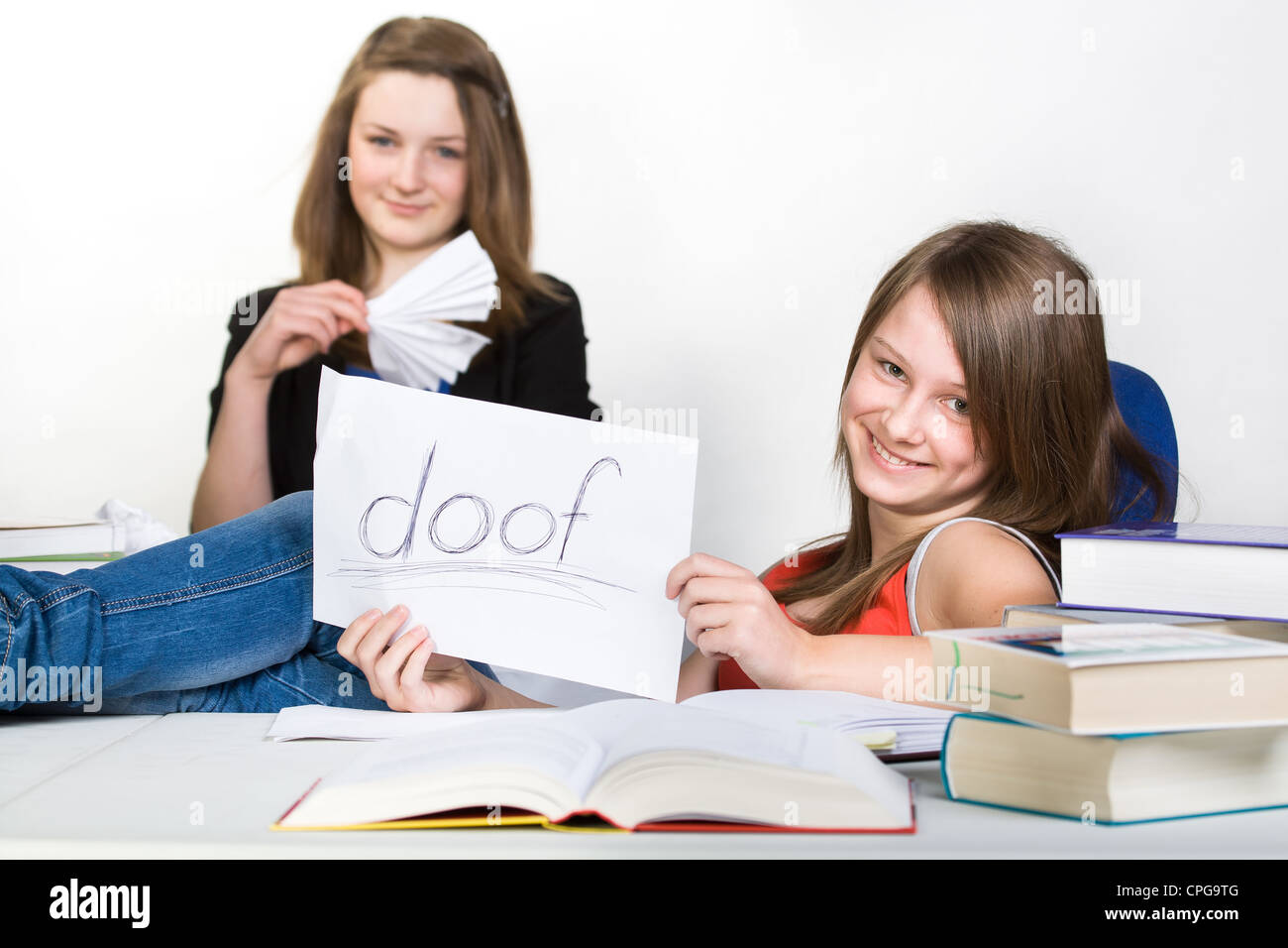 a teenage schoolgirl learning at the table Stock Photo - Alamy