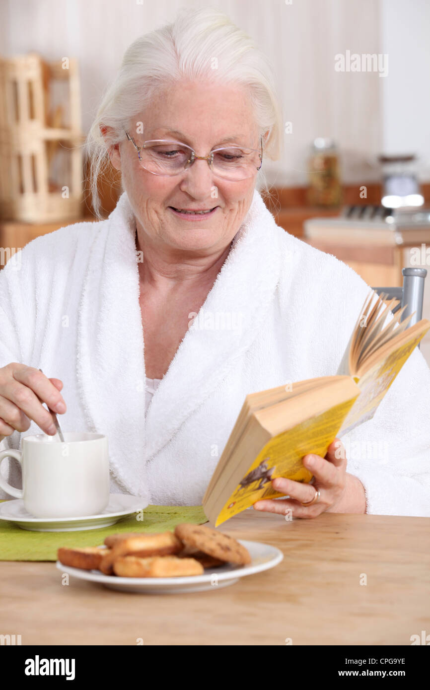 Elderly lady eating biscuits hi-res stock photography and images - Alamy